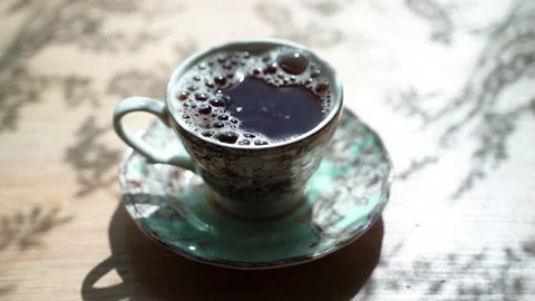 Reverse effect. Pouring black tea out of... | Stock Video | Pond5