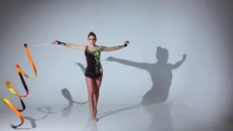 Rhythmic gymnast doing acrobatic moves w... | Stock Video | Pond5