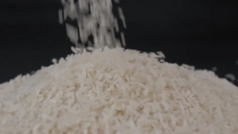 rice falling black background | Stock Video | Pond5