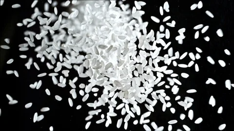 Rice grains falling on camera at black b... | Stock Video | Pond5