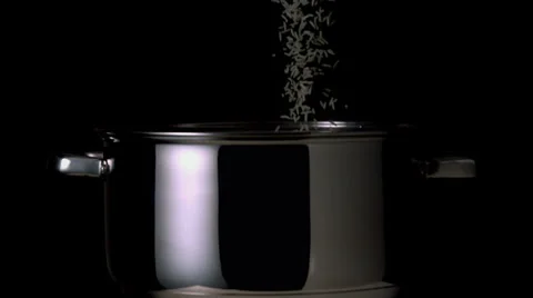Rice pouring into pot on black backgroun... | Stock Video | Pond5