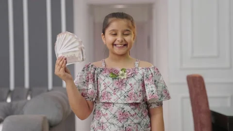 Rich Indian kid girl playing with money | Stock Video | Pond5