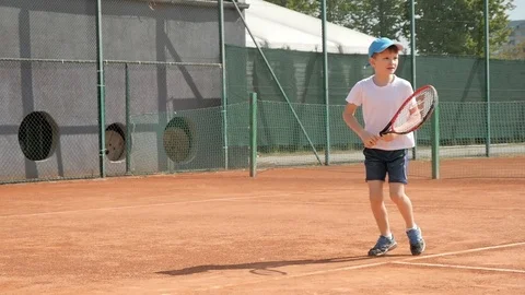 Rich Kid Boy playing Tennis on a Cort wi... | Stock Video | Pond5