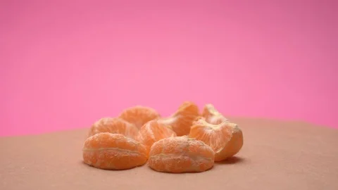 Ripe peeled mandarin, rotate on pink and... | Stock Video | Pond5