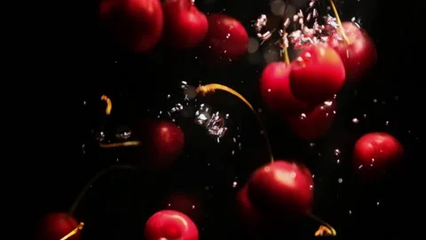 Ripe red cherry falling in water with sh... | Stock Video | Pond5