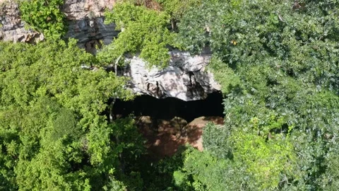 Rising drone aerial shot of the cave ent... | Stock Video | Pond5