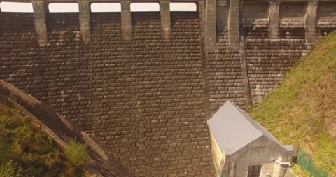 Rising shot up and over dam revealing hu... | Stock Video | Pond5