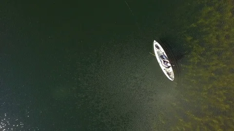Rising top down view of woman fishing in... | Stock Video | Pond5