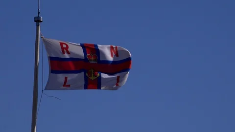 RNLI Flag blowing in the blue sky 4K | Stock Video | Pond5