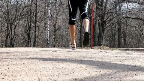 Road Runner Man Running In Park Low Angl... | Stock Video | Pond5