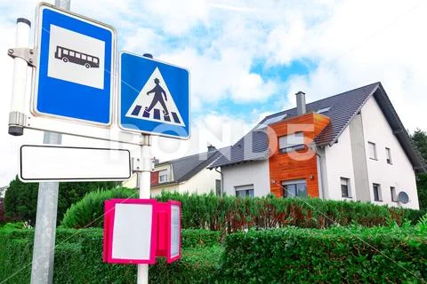 Road signs and modern houses Stock Image ~ #246138241