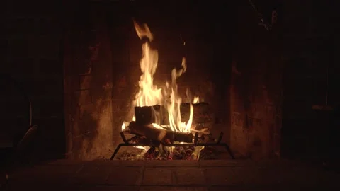 Roaring fire burns logs in brick firepla... | Stock Video | Pond5