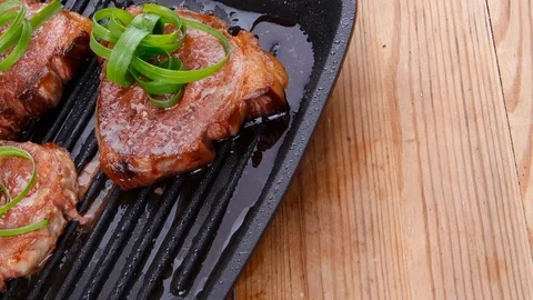 roast bloody beef fillet steaks on black... | Stock Video | Pond5