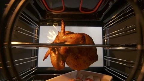 Roast whole chicken spinning on rotisser... | Stock Video | Pond5