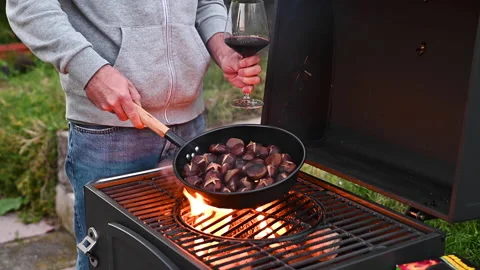 Roasted chestnuts and maroni over the fi... | Stock Video | Pond5
