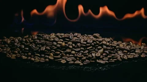 Roasted coffee beans in flame on a black... | Stock Video | Pond5
