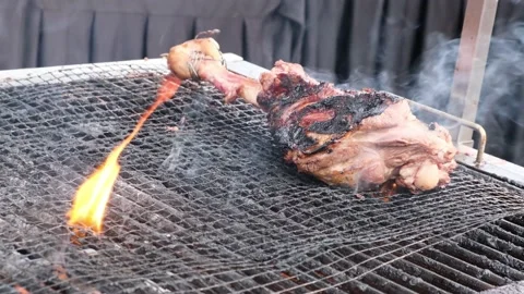Roasted lamb mutton leg is burned with f... | Stock Video | Pond5