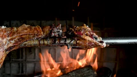 Roasted lamb. Sheep on a spit above fire... | Stock Video | Pond5