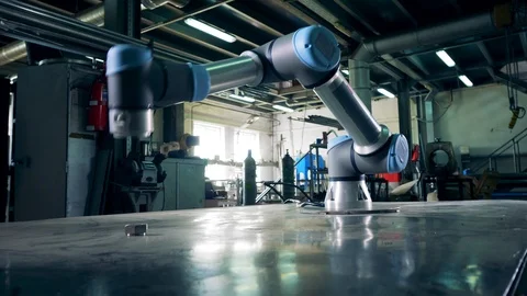 Robotic arm moves over a gear while work... | Stock Video | Pond5