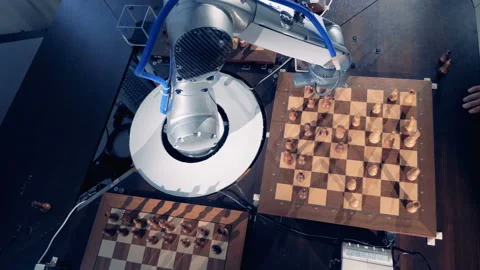 A robotic arm is moving chess pieces bei... | Stock Video | Pond5