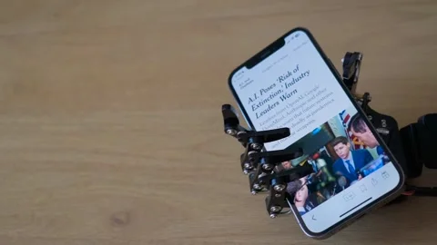 Robotic Hand Holding Phone With AI News ... | Stock Video | Pond5