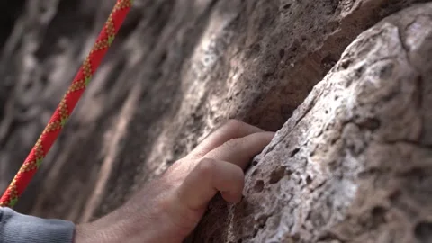 A rock climber grabbing for a hand hold ... | Stock Video | Pond5