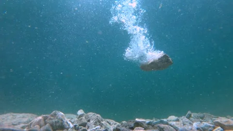 Rock falling in water. Underwater view o... | Stock Video | Pond5