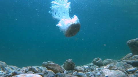 Rock falling in water. Underwater view o... | Stock Video | Pond5