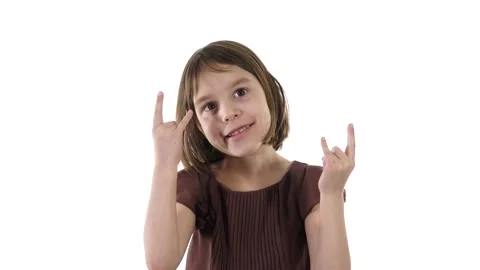 Rock N Roll hand gesture. Little girl sh... | Stock Video | Pond5