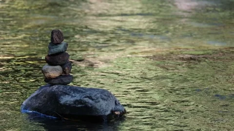 Rock Stacking, a shorter stack with one ... | Stock Video | Pond5