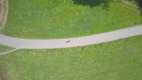 Rollerblading in a green park path - Top... | Stock Video | Pond5