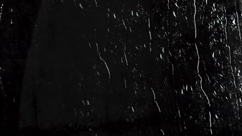 Rolling drops of water on black backgrou... | Stock Video | Pond5