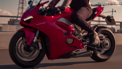 Rolling shot of man biker riding red Duc... | Stock Video | Pond5