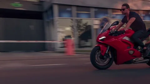 Rolling shot of man biker riding red Duc... | Stock Video | Pond5