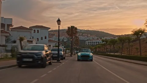 Rolling shot of woman driving Mini Coope... | Stock Video | Pond5