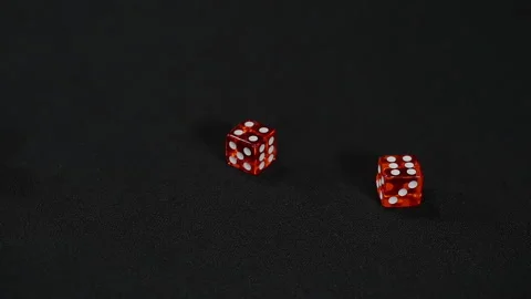 Rolling two red dice on black background... | Stock Video | Pond5