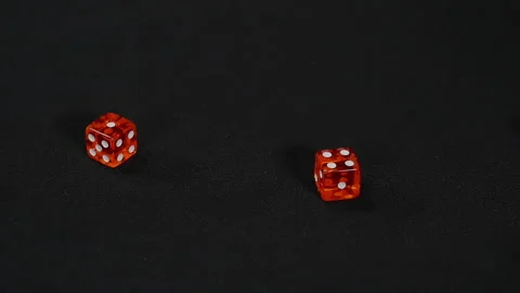 Rolling two red dice on black background... | Stock Video | Pond5