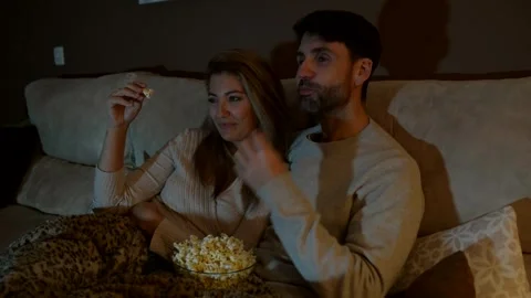 Romantic couple sharing popcorn while wa... | Stock Video | Pond5