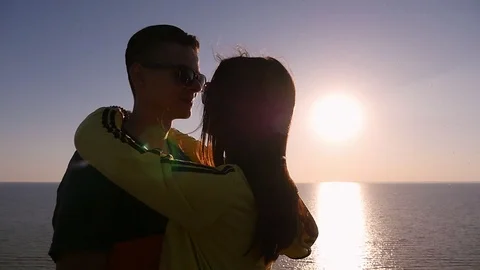 Romantic pair hugs at a magic sunset at ... | Stock Video | Pond5