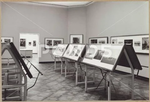 Room with objects in wall lists and in sloping display cases, links a ...