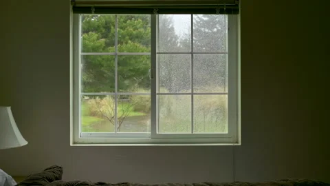 A room with a window. Rain storm outside... | Stock Video | Pond5