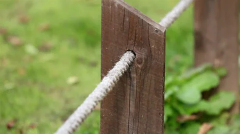 rope fence run through the hole of the w... | Stock Video | Pond5