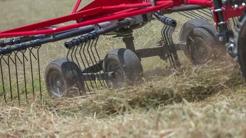 Rotary rakes are sorting out hay into pi... | Stock Video | Pond5