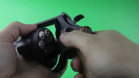 Rotate the revolver drum,on the green ba... | Stock Video | Pond5