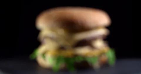 Rotating Burger on Black Background | Stock Video | Pond5
