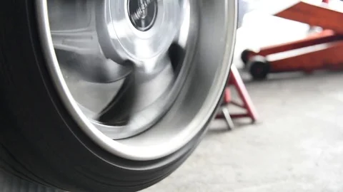 Rotating a car wheels for checking car s... | Stock Video | Pond5