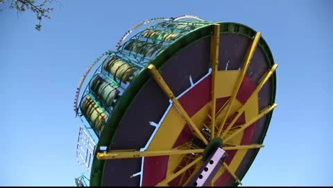 Rotating carousel with people in an amus... | Stock Video | Pond5