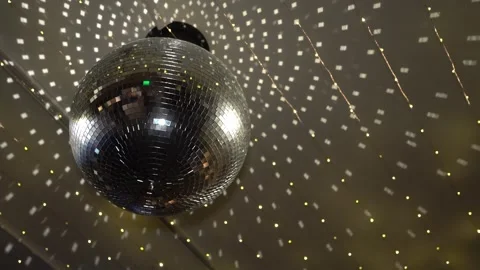 Rotating disco ball hanging from the cei... | Stock Video | Pond5