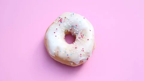 rotating donut with colorful toppings on... | Stock Video | Pond5