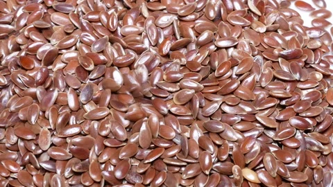 Rotating of falling flex seed on white b... | Stock Video | Pond5